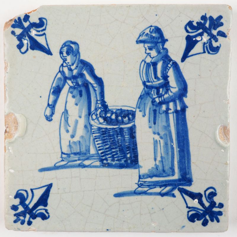 Antique Delft tile with two women carrying goods, 17th century
