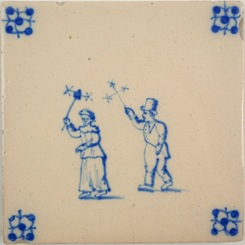 Antique Delft tile with two people playing with windmills, 20th century