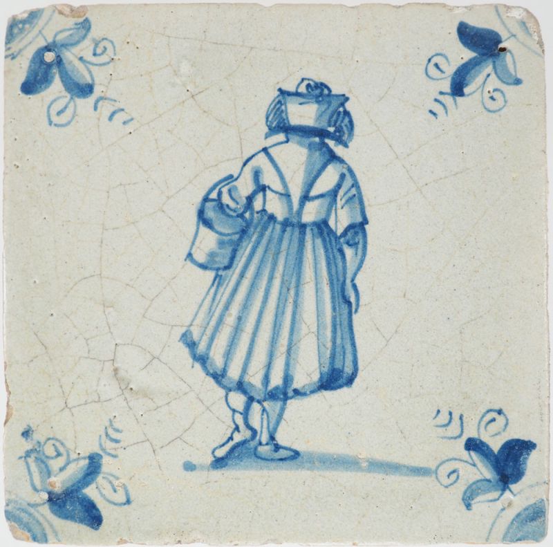 Antique Delft tile with a woman carrying goods, 17th century