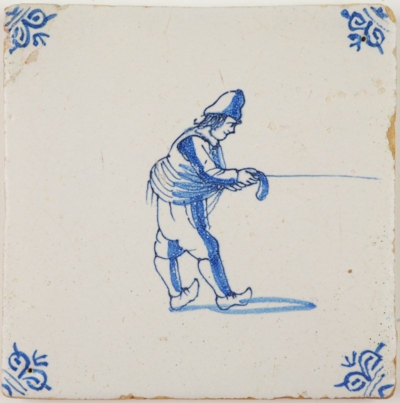 Antique Delft tile with a man in blue spinning a rope, 17th century